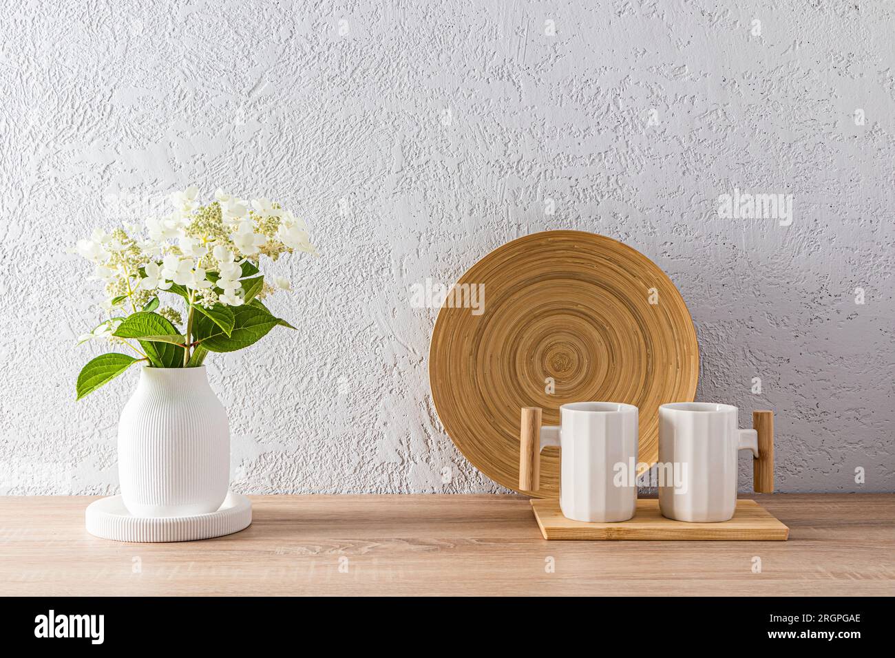 Stylish white ceramic mugs with a wooden handle on the kitchen ...