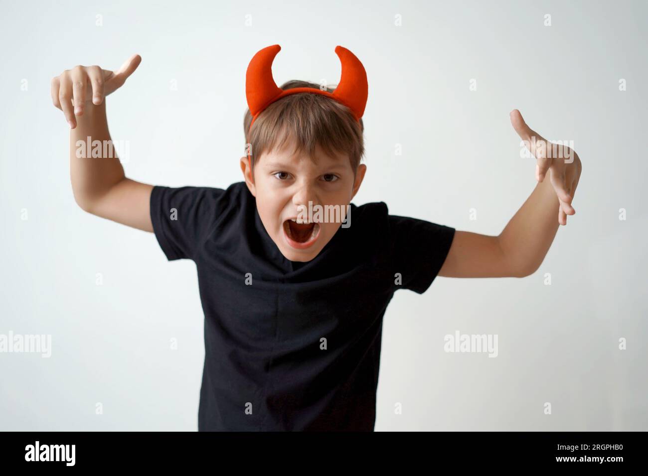 Halloween concept. cute little boy with red devil horns and pumpkin ...