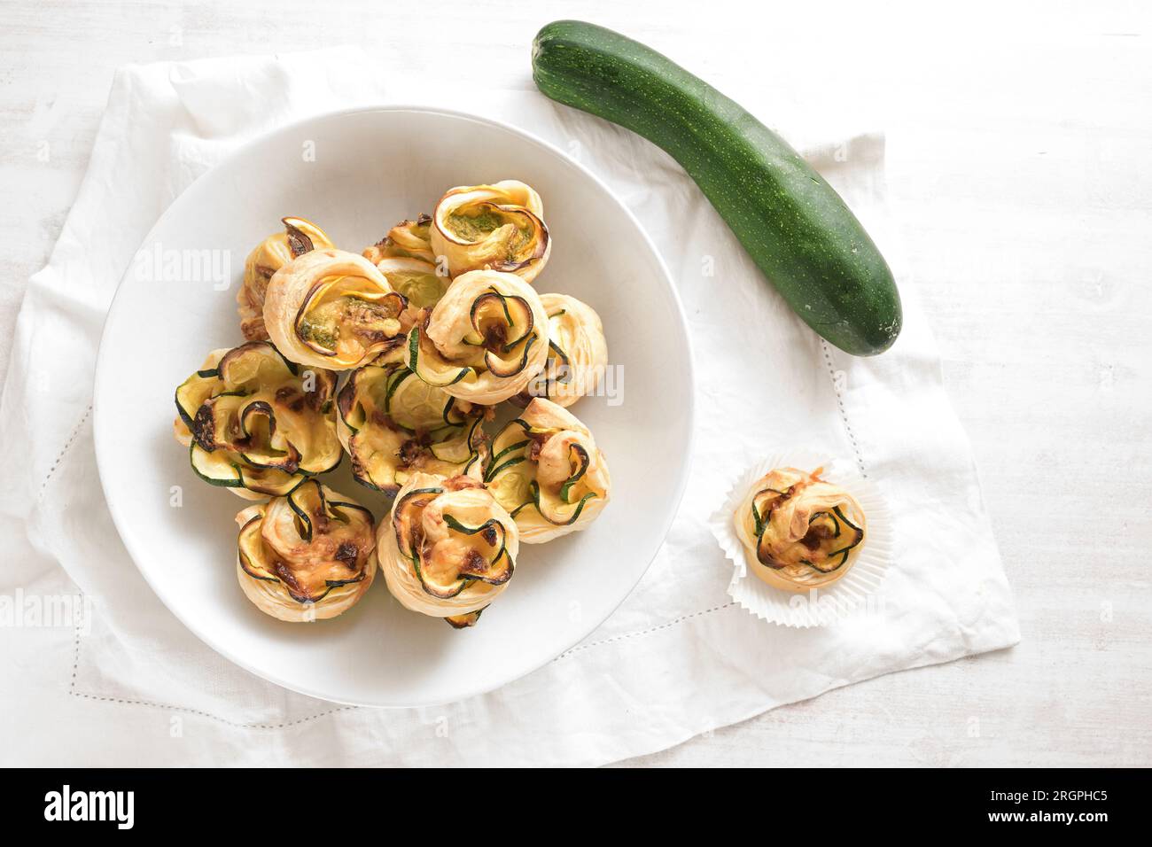 Zucchini muffins made with puff pastry, finger food snack in a white ...