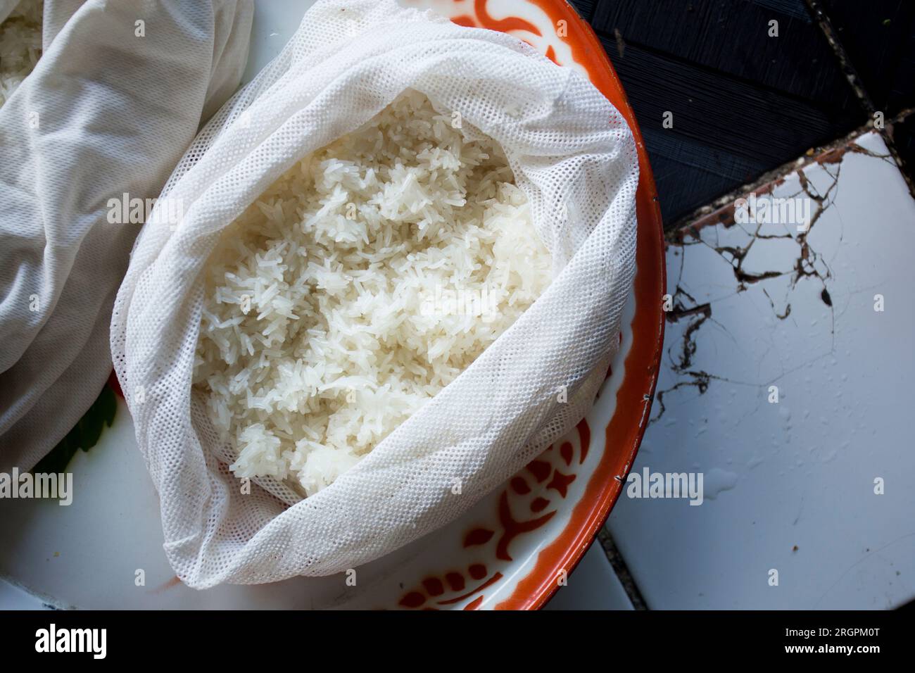 Cooked rice inside a white cloth bag in a kitchen in Bangkok, Thailand ...