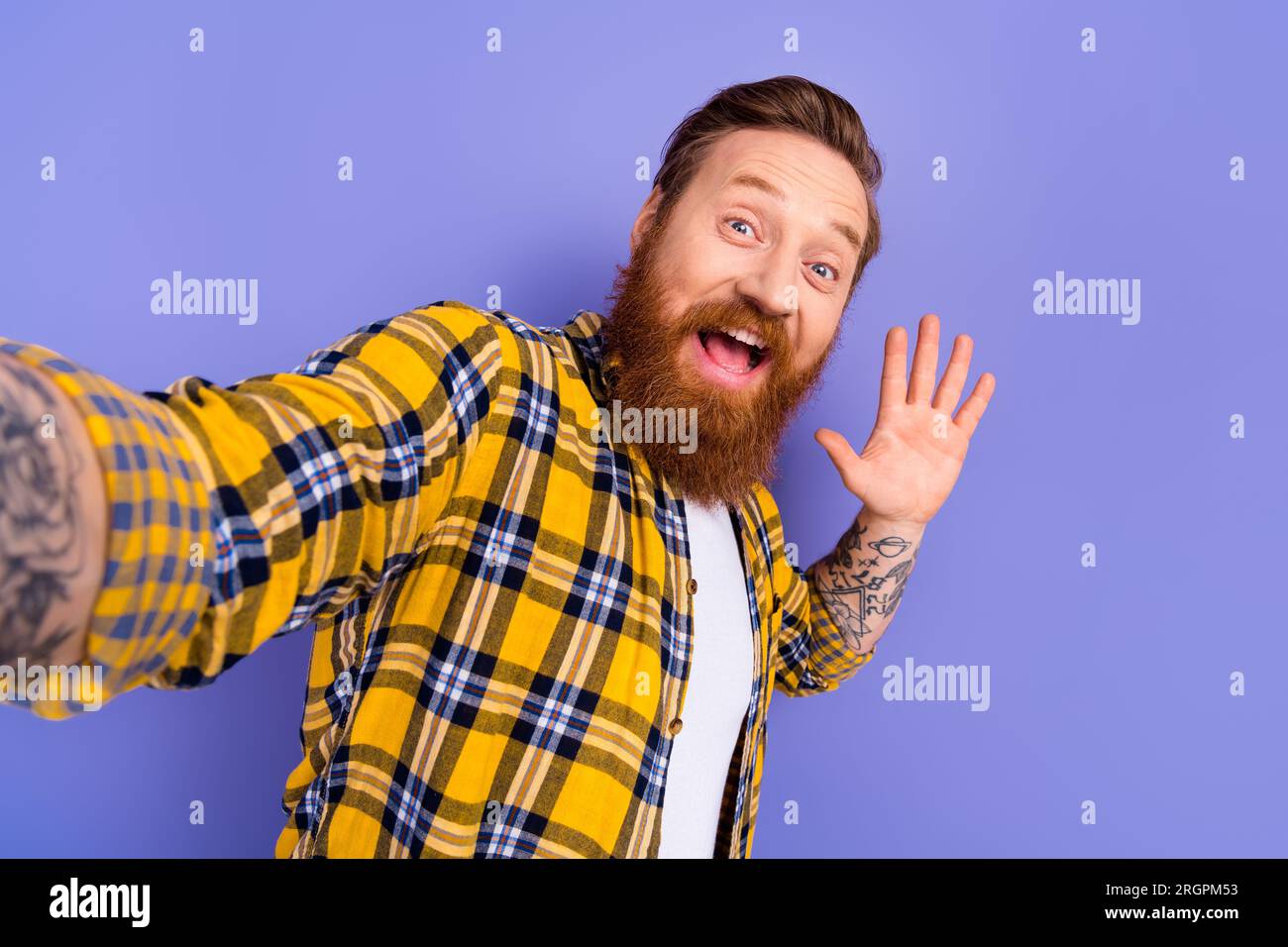 Photo of excited positve man blogger waving hand palm hello followers ...