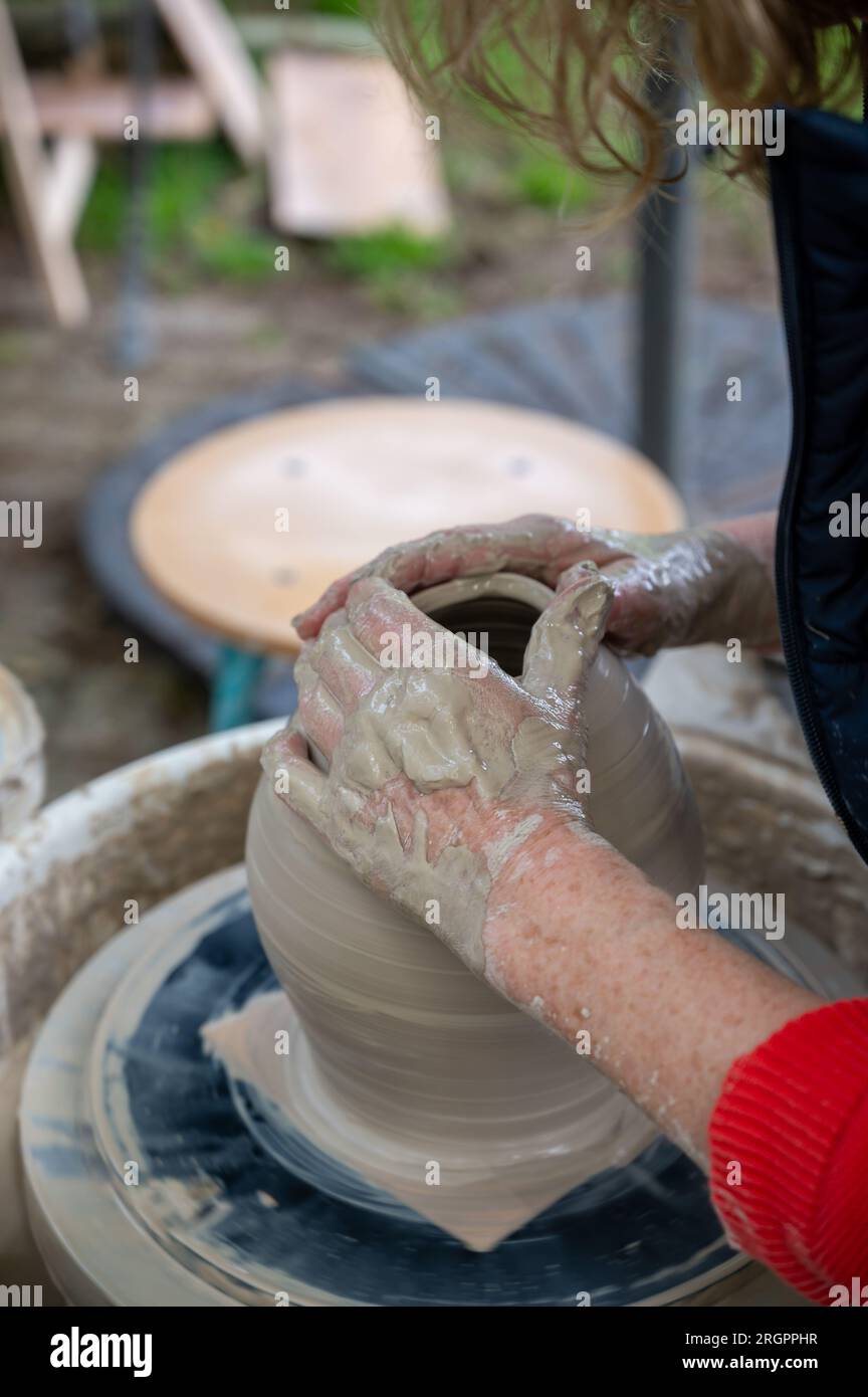 Making of mud pot on potters wheel during workshop outdoor in ...