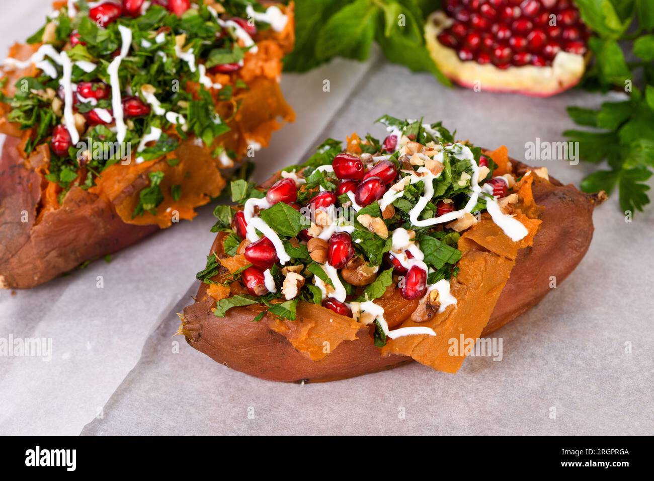 Baked stuffed sweet potatoes filled with walnuts, fresh herbs, mint and ...