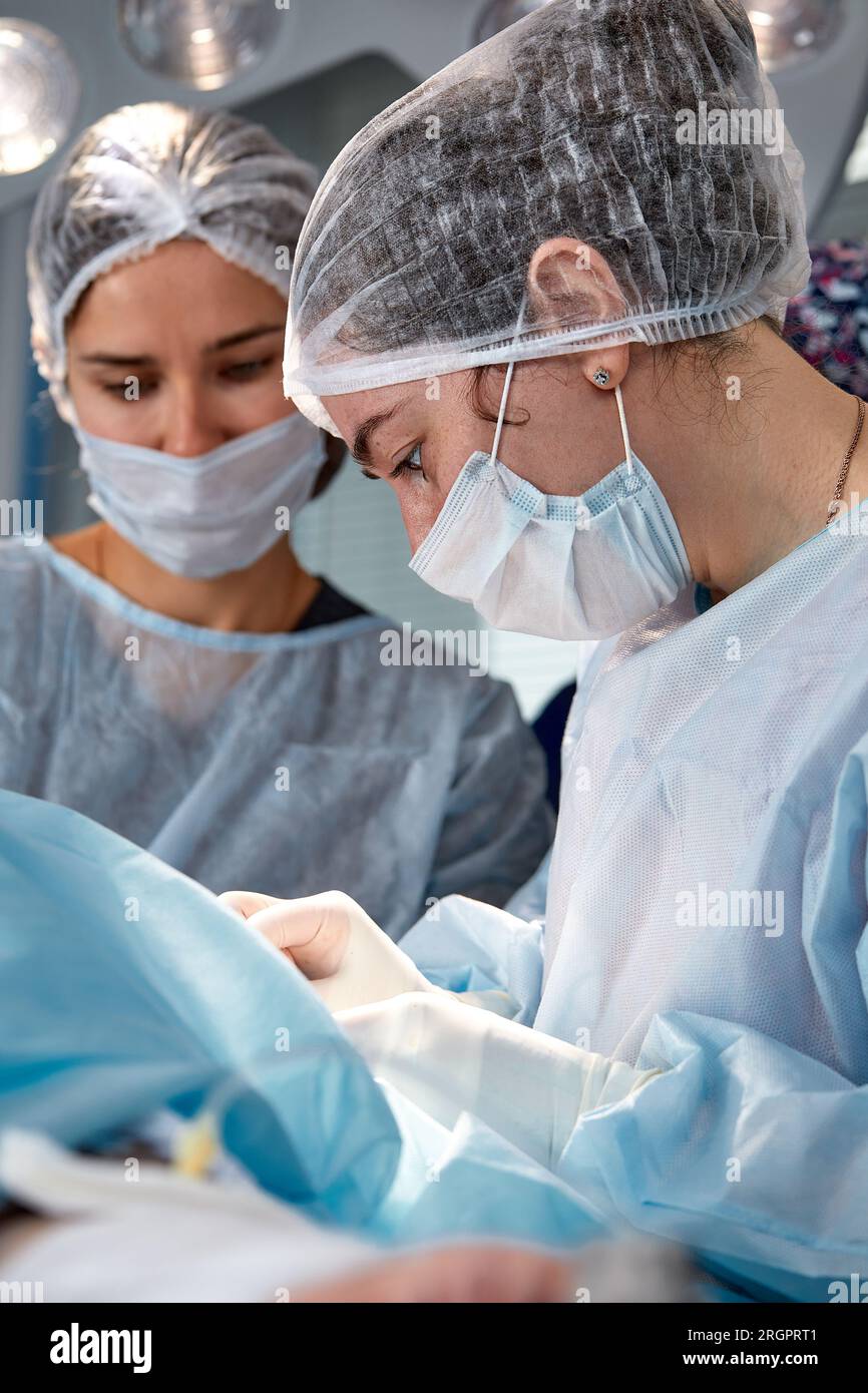 Close-up of a female surgeon in an operating room, a doctor with a ...
