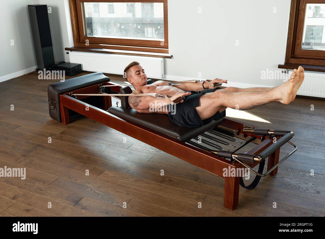 Pilates reformer workout exercises man at gym indoor Stock Photo - Alamy