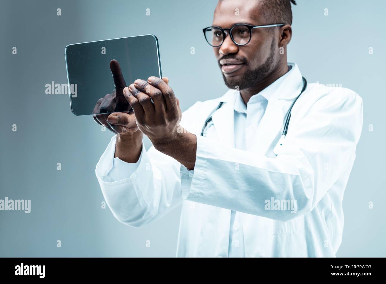Medical doctor using high-tech tablet for work (blank screen for YOUR ...