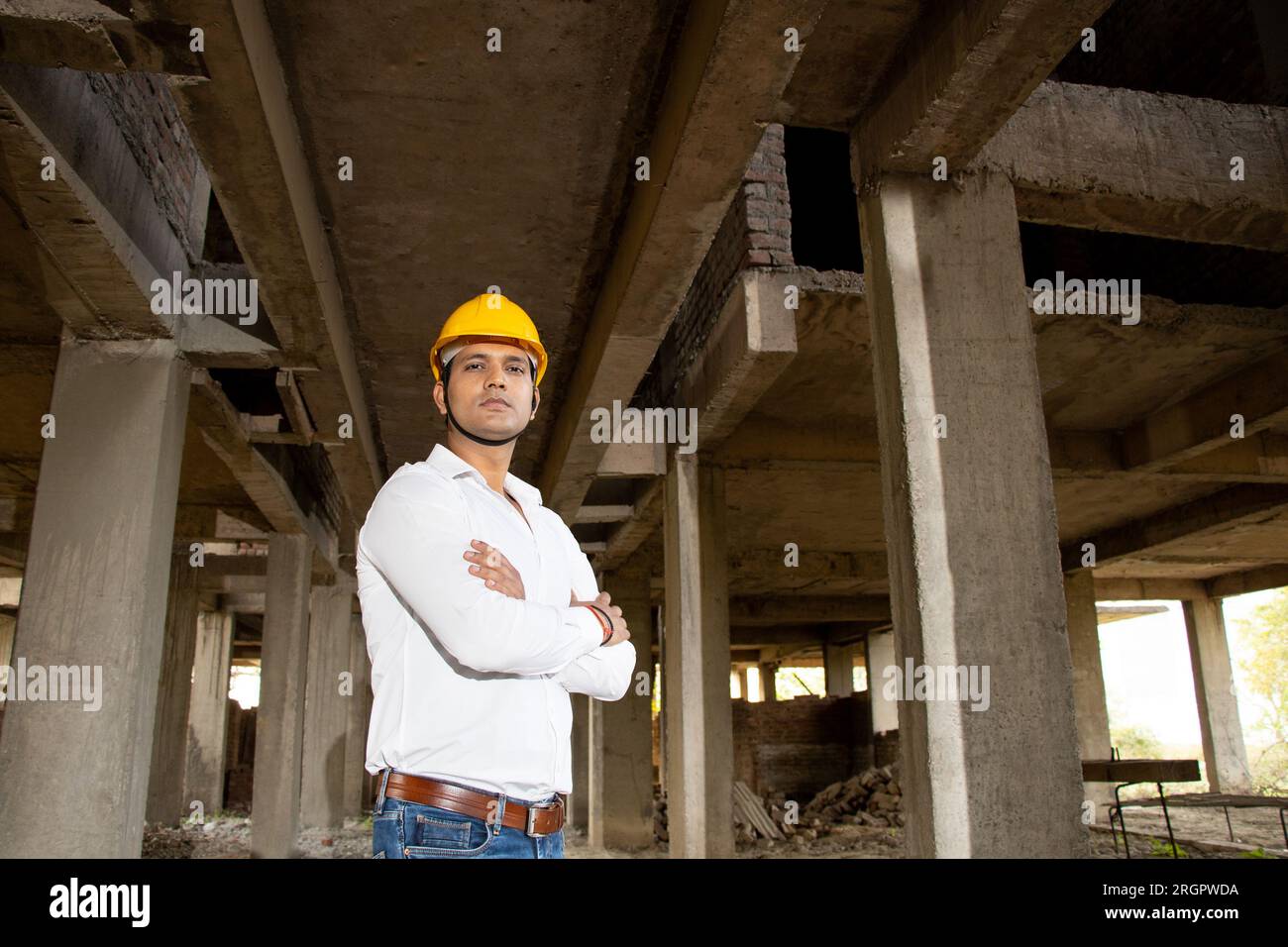 Portrait of happy young handsome Indian male civil engineer or ...