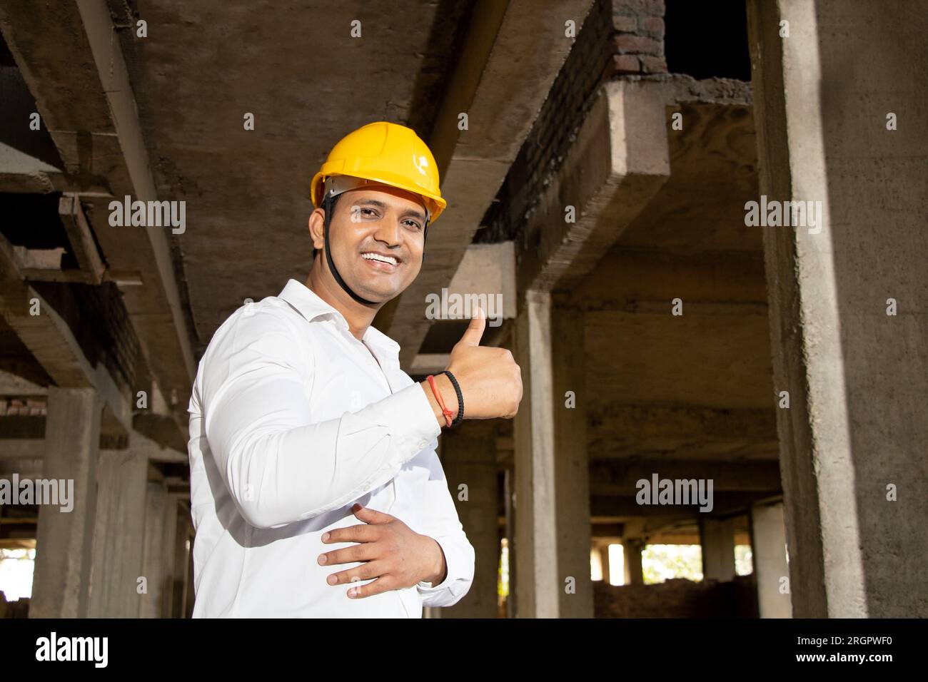 Portrait of happy young handsome Indian male civil engineer or ...