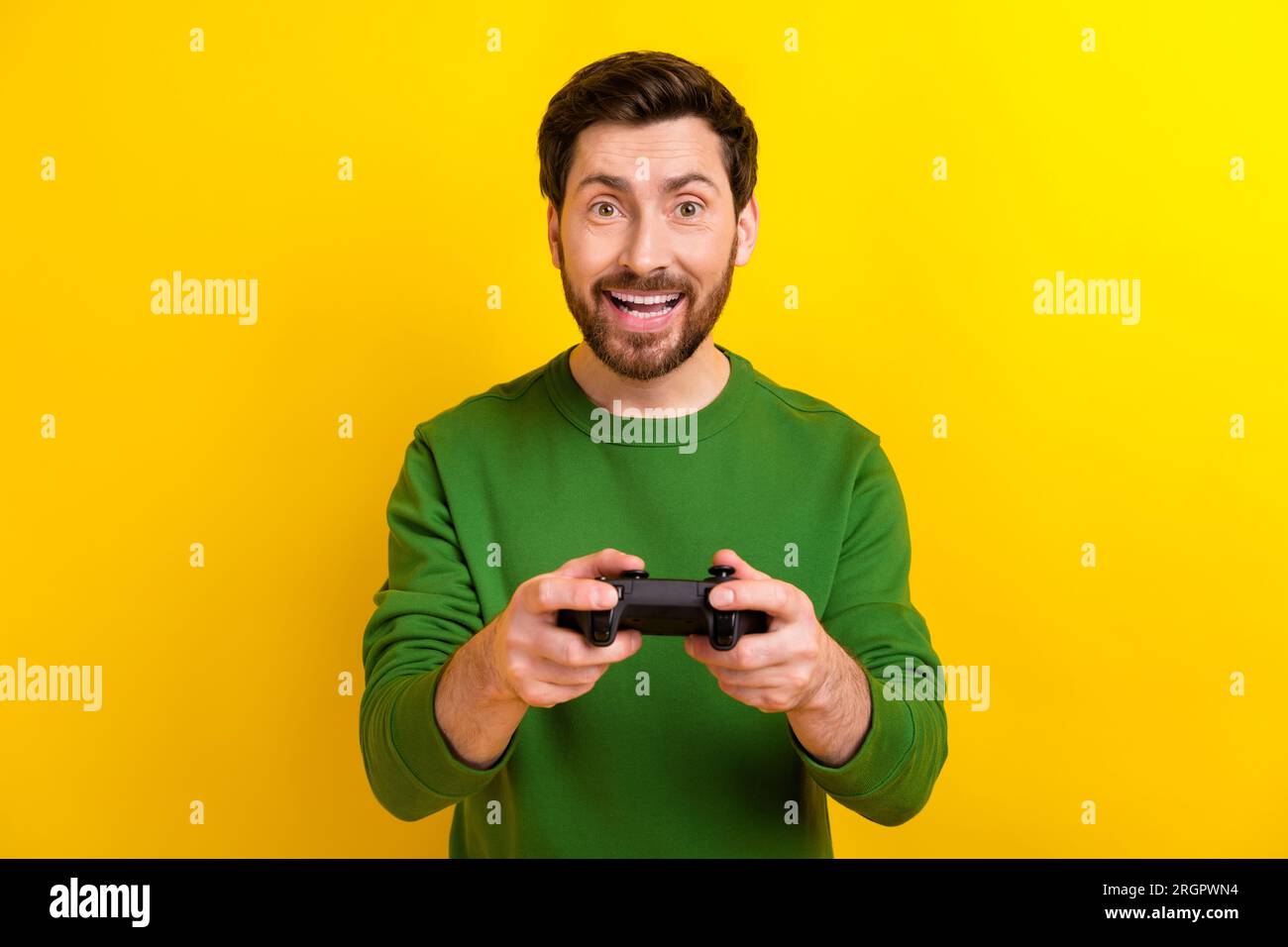 Photo of addicted gamer young guy brunet holding wireless joystick new ...