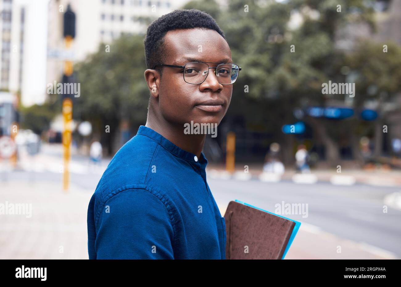 Portrait, serious student and black man in city outdoor to travel to ...