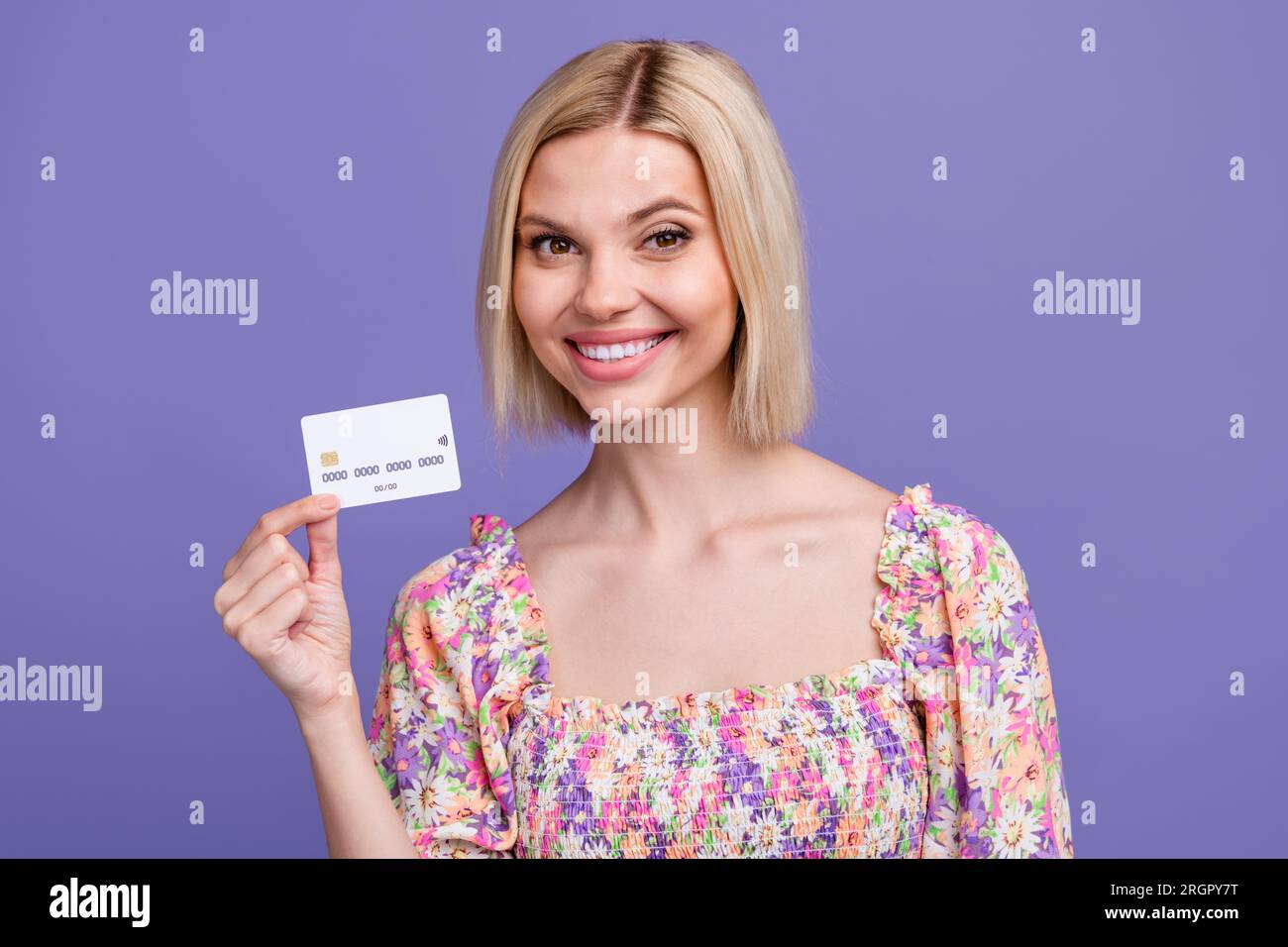 Portrait of positive lovely girl toothy smile arm hold showing debit ...