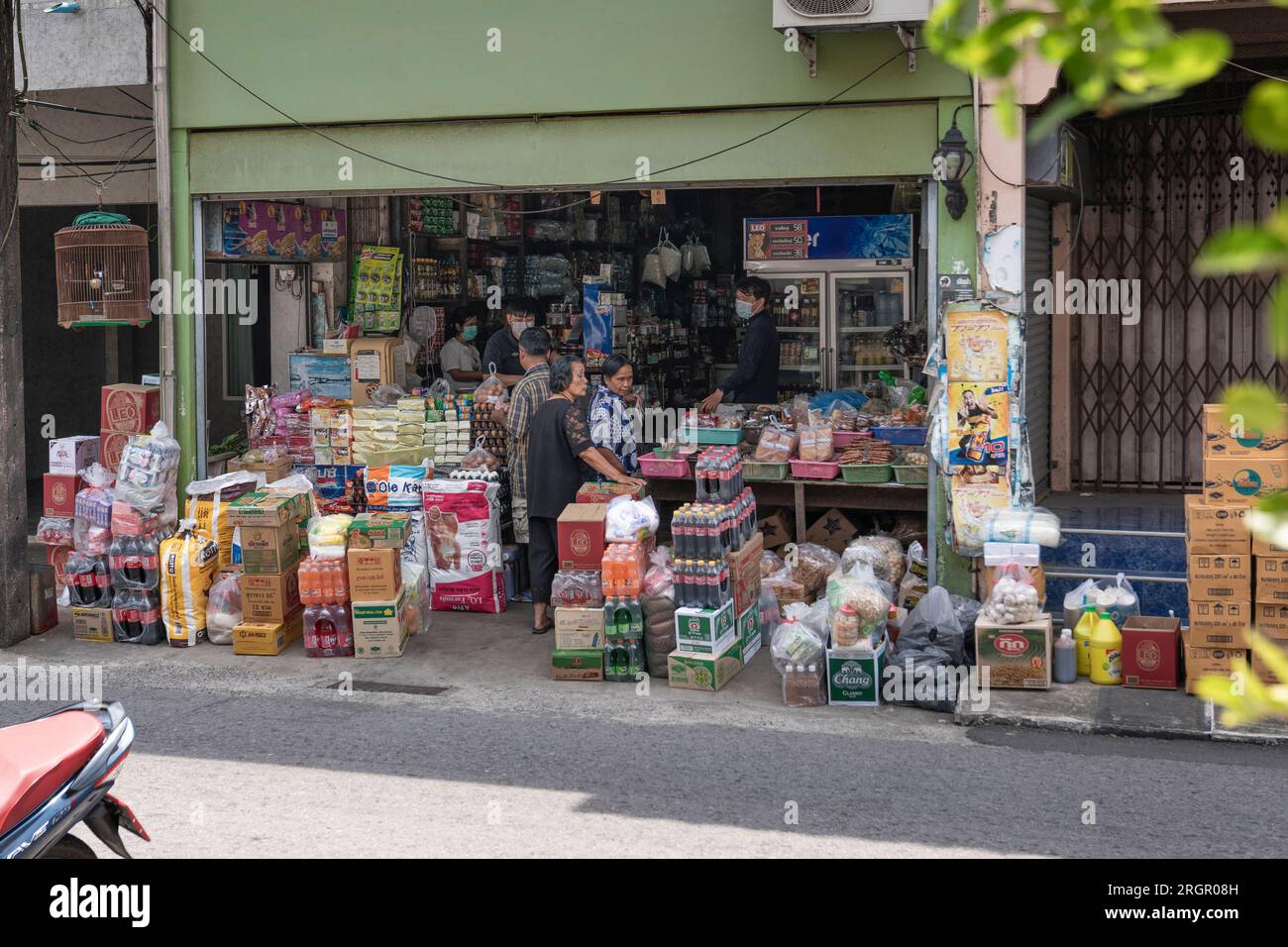A typical traditional shop in Thailand. People shop at a street grocery ...