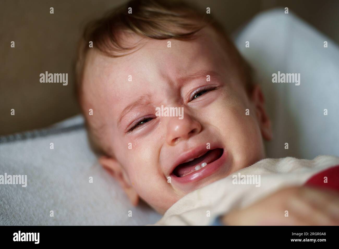 Agitated baby crying Stock Photo - Alamy