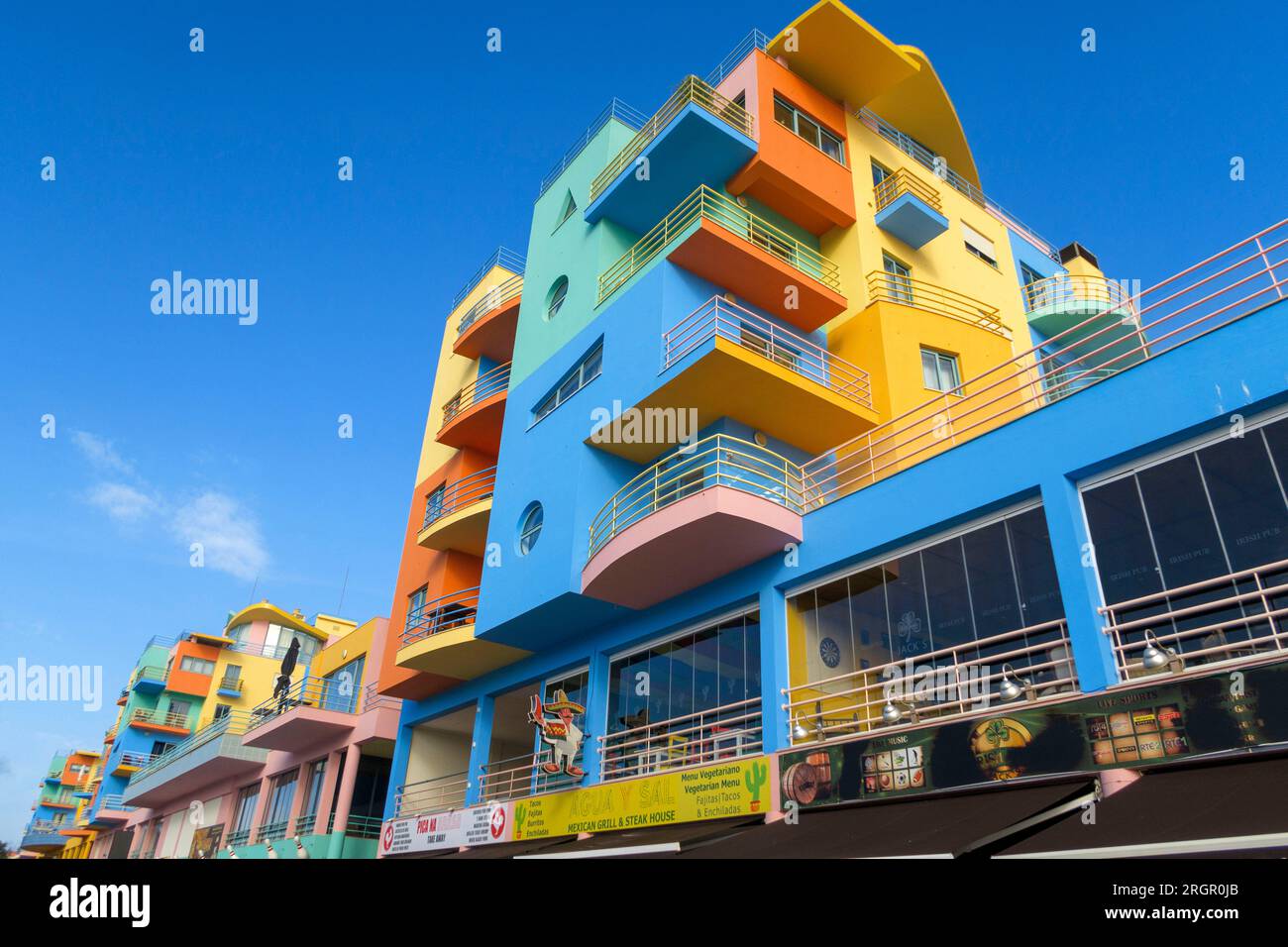 Multi color apartment buildings in front of the marina in Albufeira ...