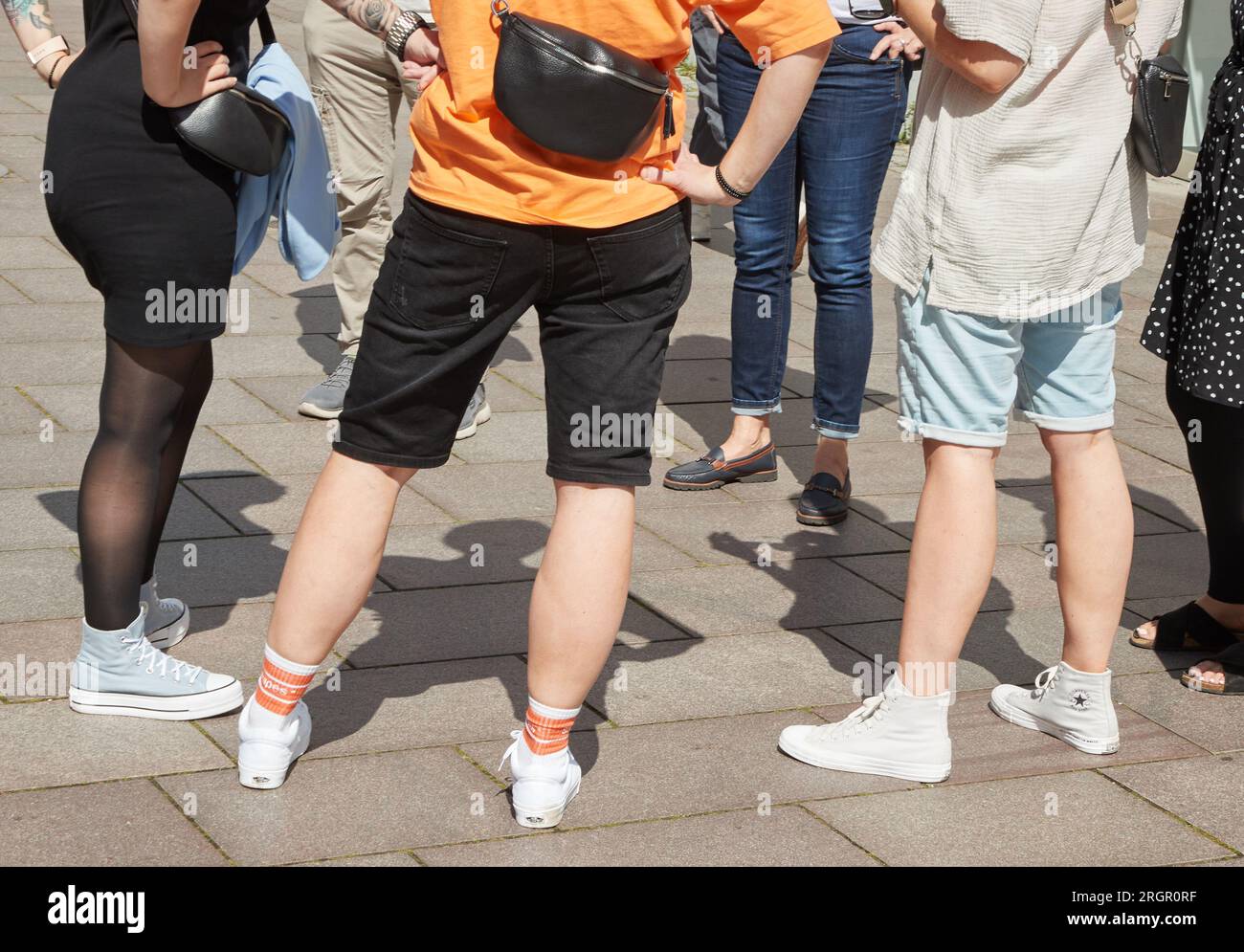 11 August 2023, Lower Saxony, Lüneburg: People are standing in a square ...