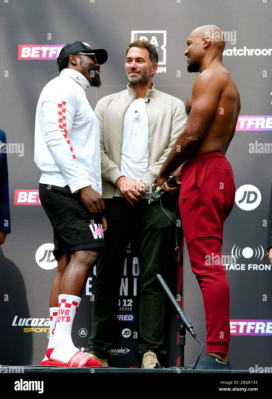 Matchroom Sport chairman and boxing promoter Eddie Hearn (centre) stands between Derek Chisora ...