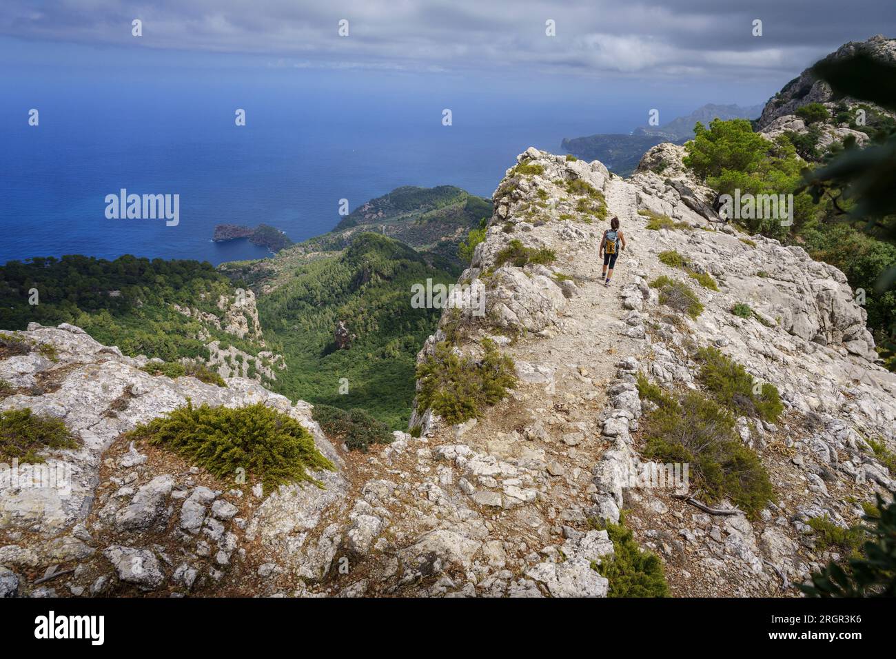 middle-aged woman walking Camí de s'Arxiduc route, Valldemossa, Majorca ...