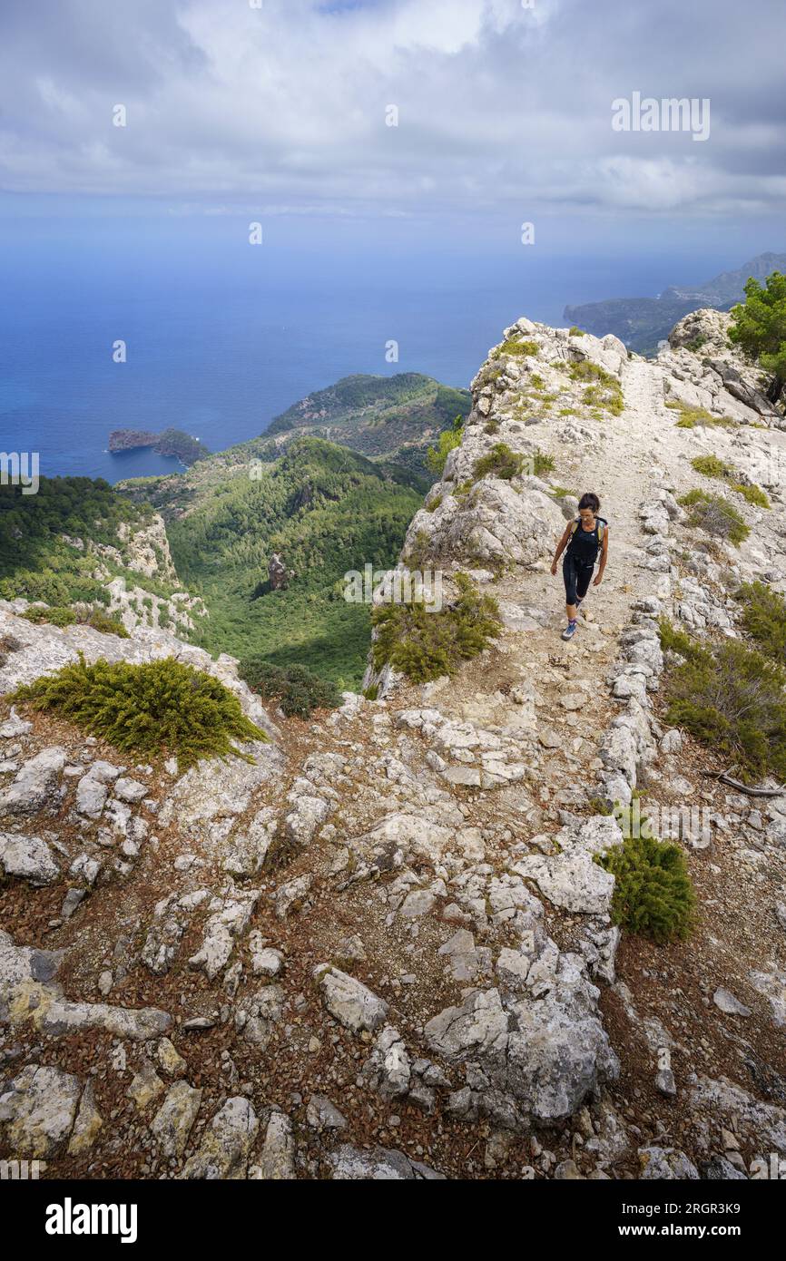 middle-aged woman walking Camí de s'Arxiduc route, Valldemossa, Majorca ...