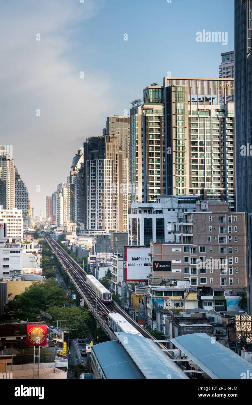 Trains coming into and leaving Phrom Phong BTS skytrain station above ...