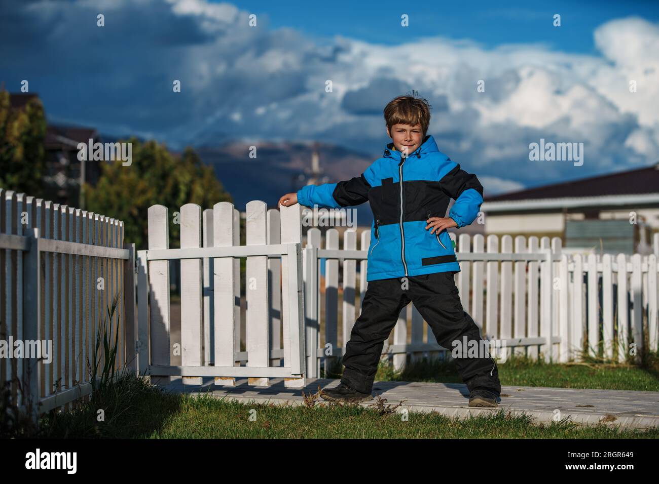 Boy in the yard of a country house in autumn season Stock Photo - Alamy