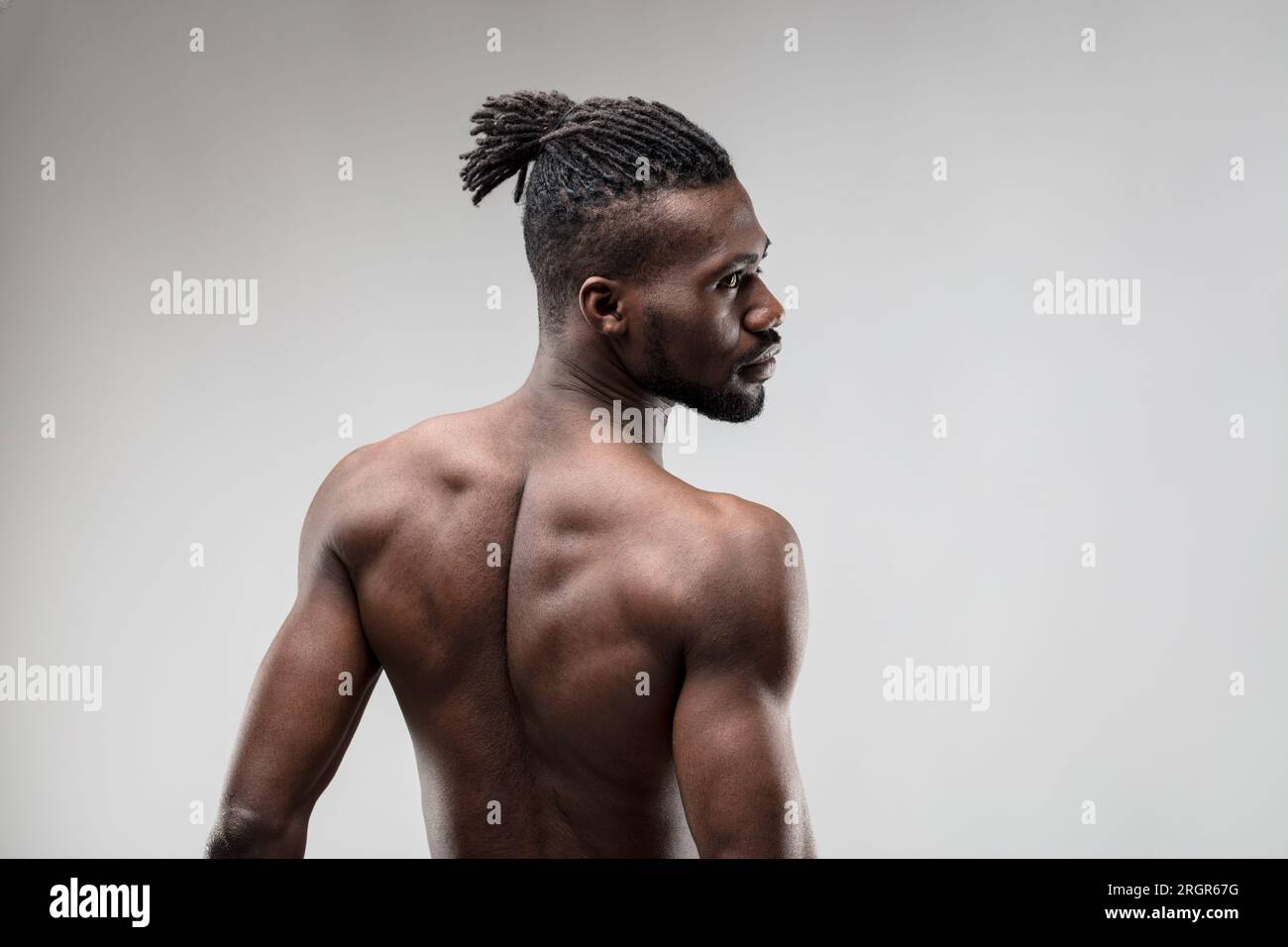 Muscular man turns sideways, displaying attractive back muscles. It's ...