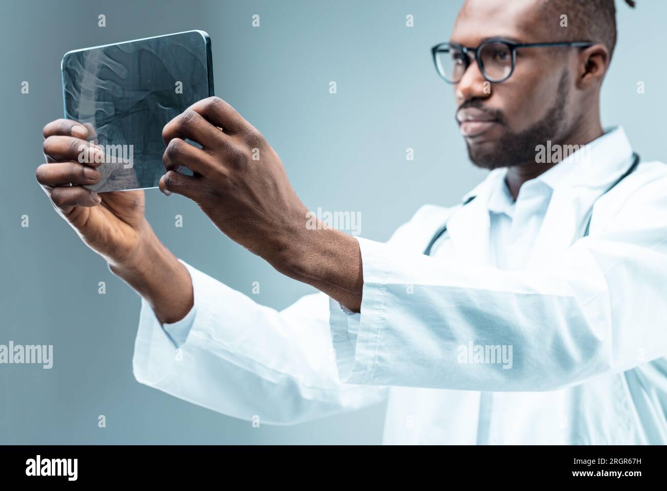 Black medical doctor uses a high-tech digital tablet. Mobile apps and ...