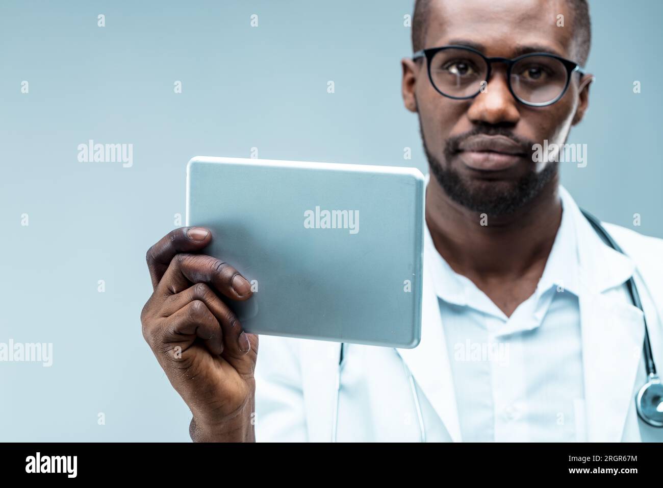Modern doctor, black man with groomed beard, uses digital tech for ...