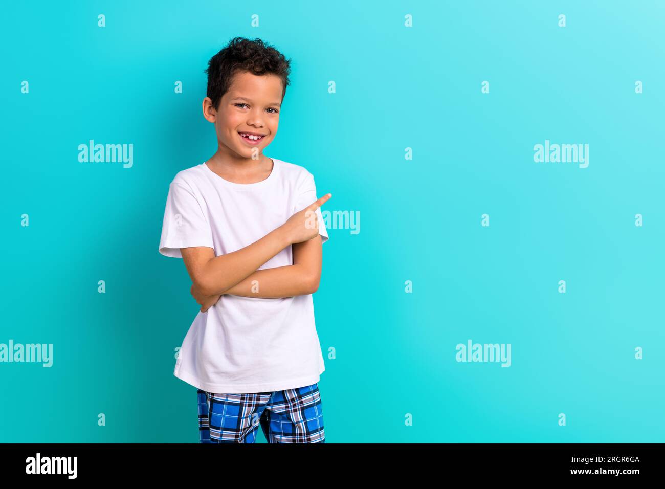 Photo of charming small kid toothy smile indicate finger empty space ...