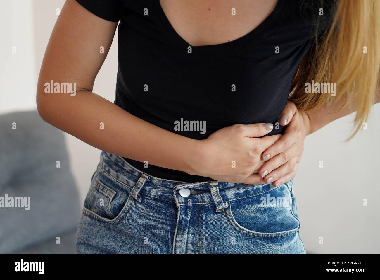 Spleen pain. Young woman suffering from abdominal pain at home. Health ...