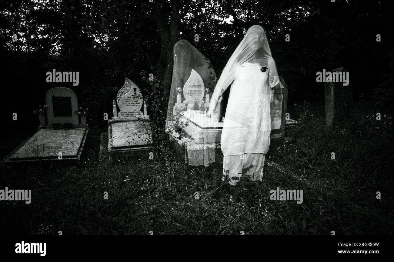 scary ghost in cemetery at night Halloween background Stock Photo - Alamy