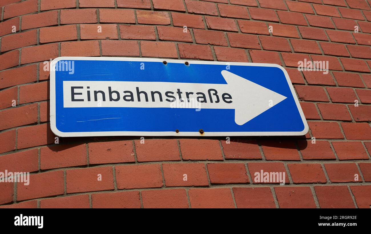 Traffic sign with German inscription Einbahnstraße on the facade of a ...