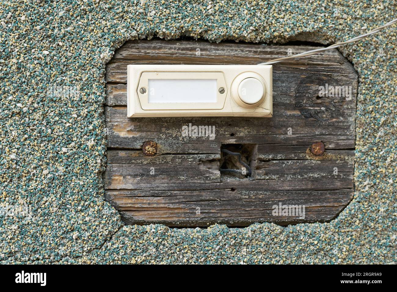 Unprofessionally installed bell button in the entrance area of a house ...