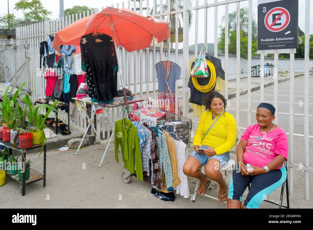 Niteroi, Brazil, Two Brazilian women work selling diverse items on a ...