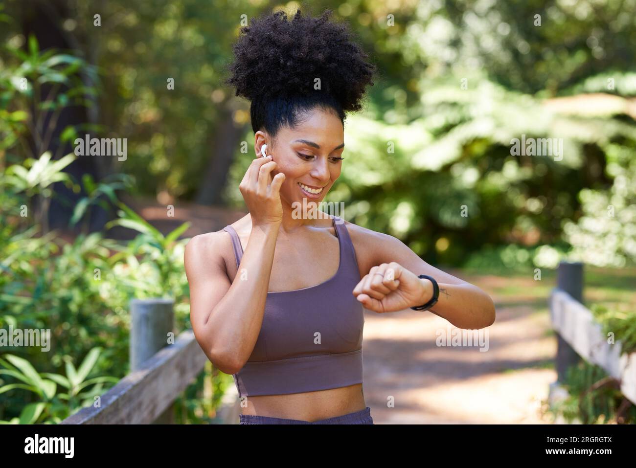 Beautiful multi-ethnic woman gets ready for trail run in forest ...