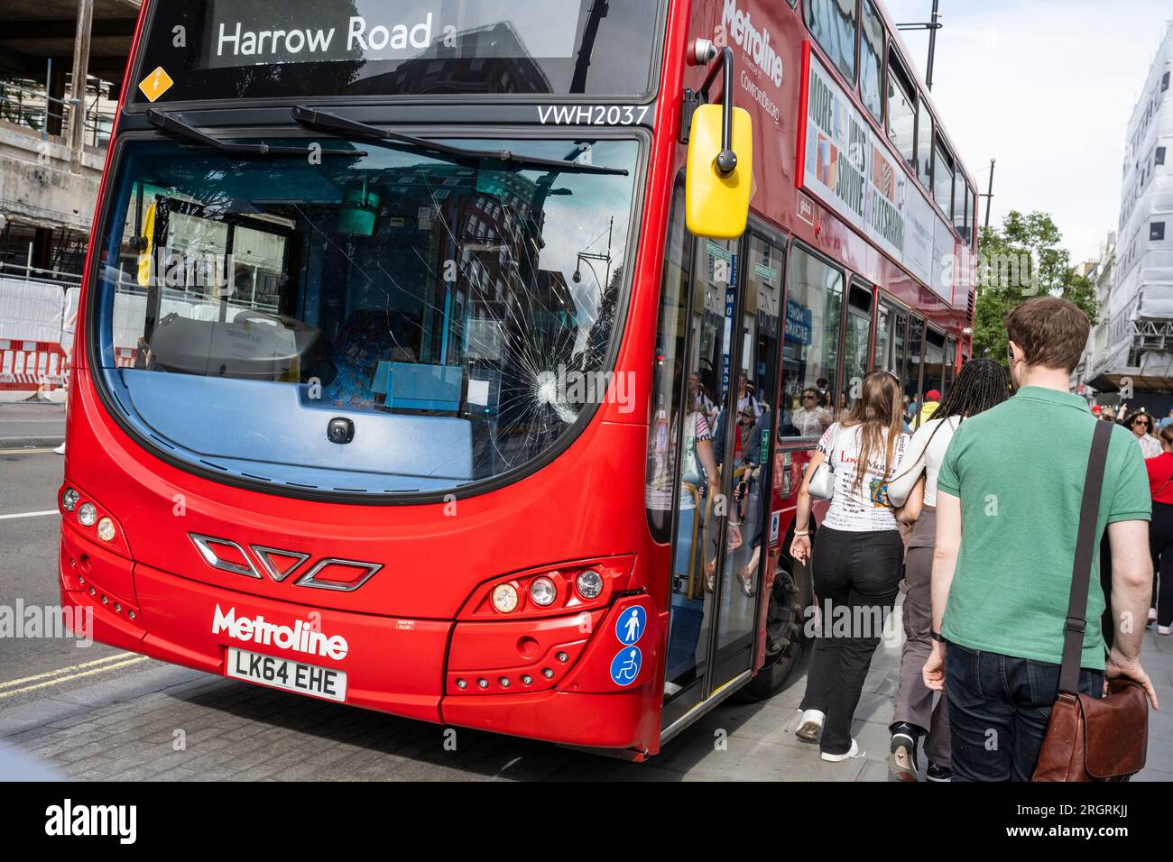 London, UK. 11 August 2023. Members of the public pass a double-decker ...