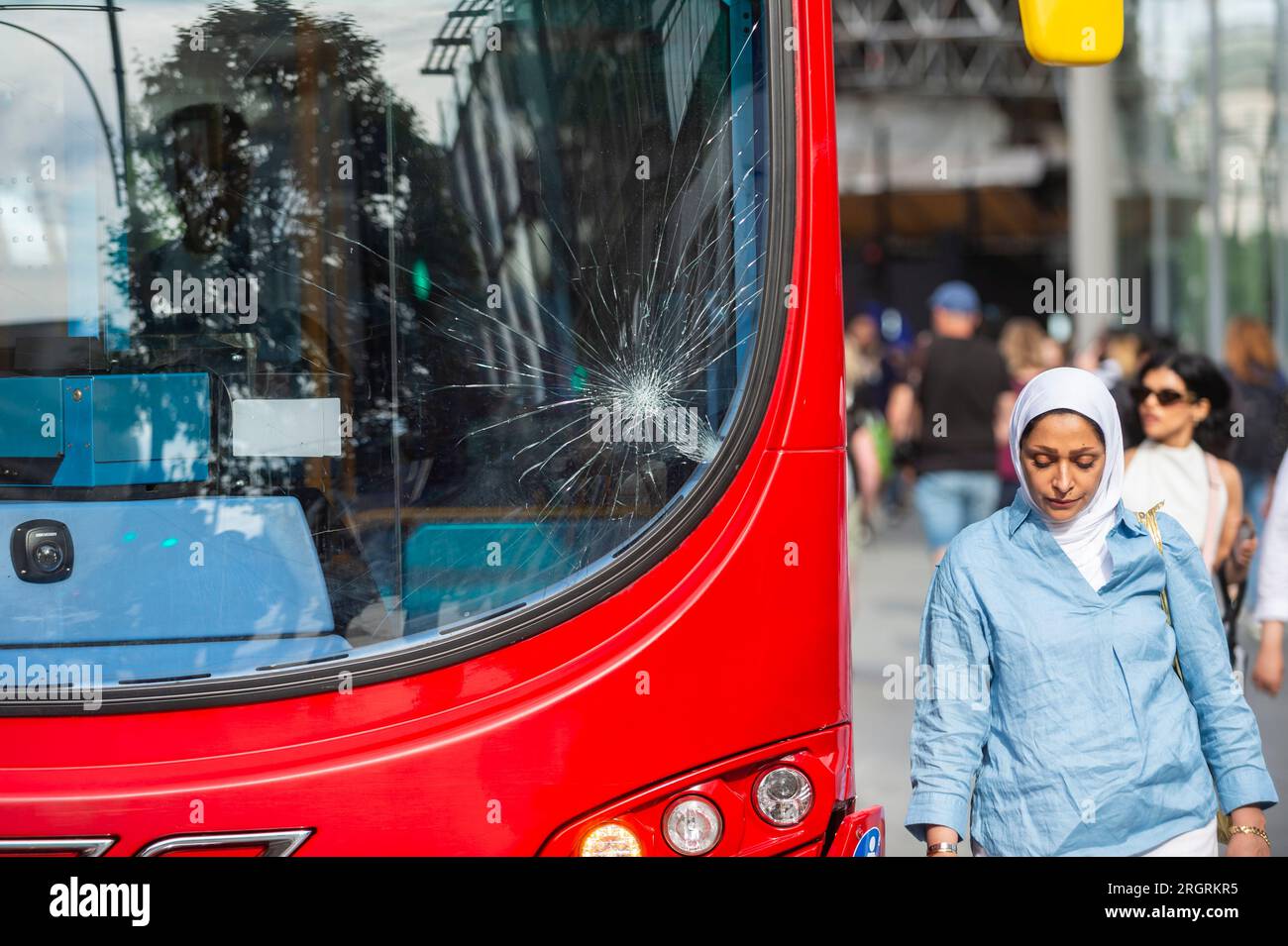 London, UK. 11 August 2023. Members of the public pass a double-decker ...