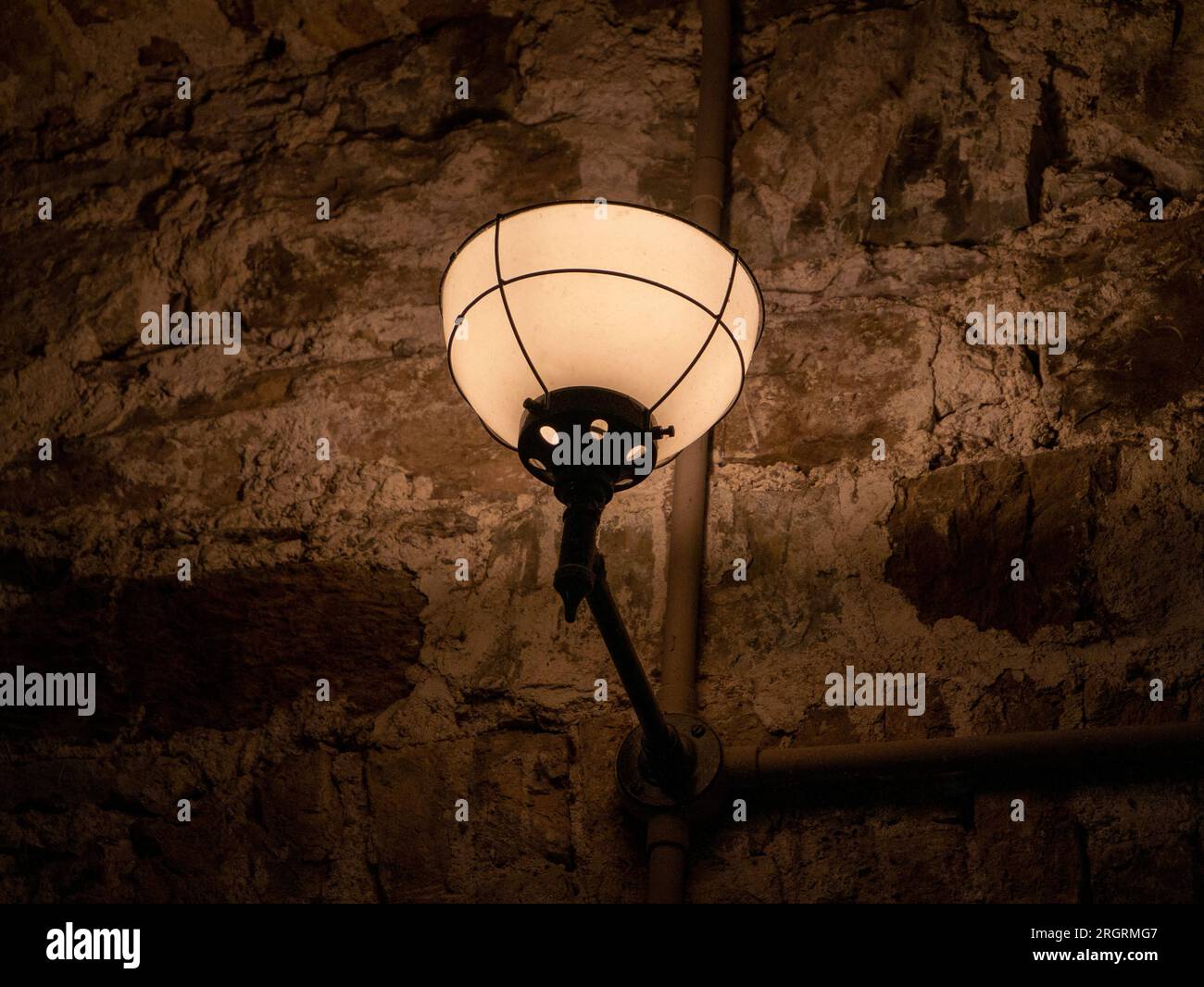 Old ancient lamp on the wall of a prison background, gloomy light Stock ...