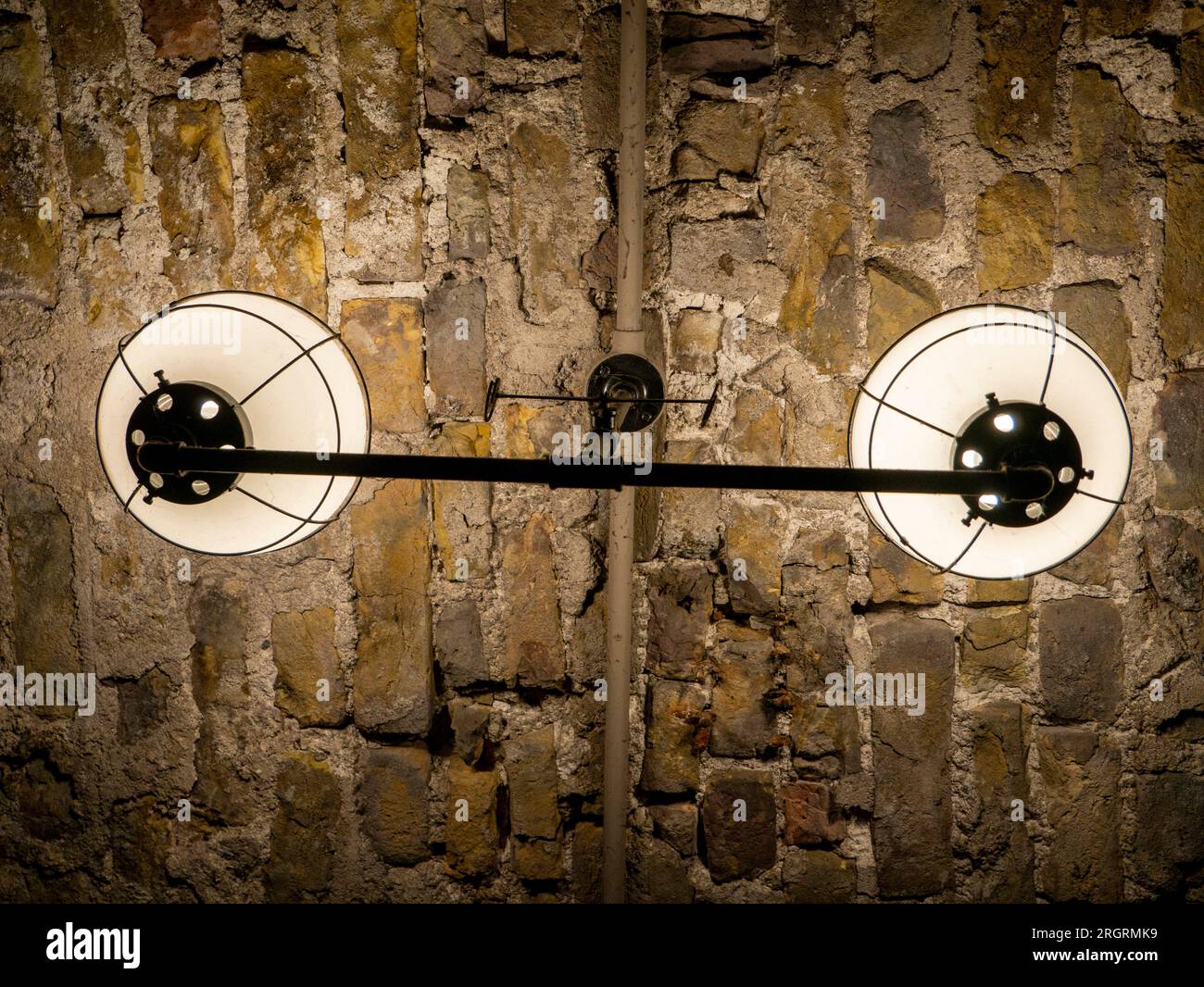Old ancient lamps on the wall in a dark room background, gloomy light ...