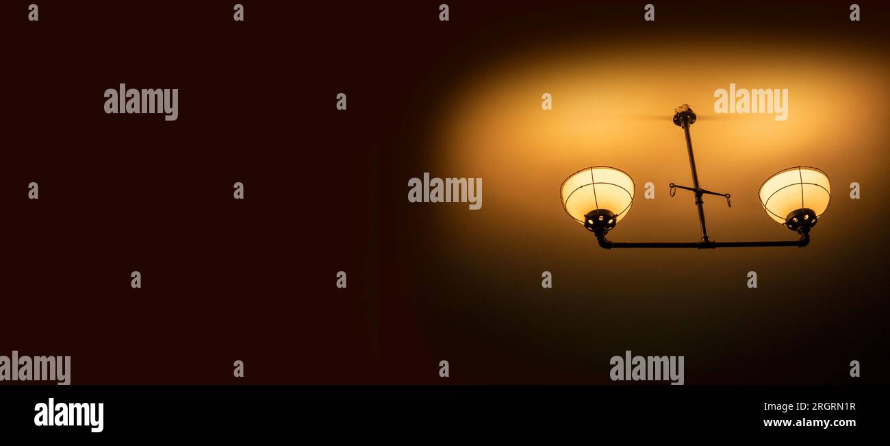 Old ancient lamps on the wall in a dark room background, gloomy light ...