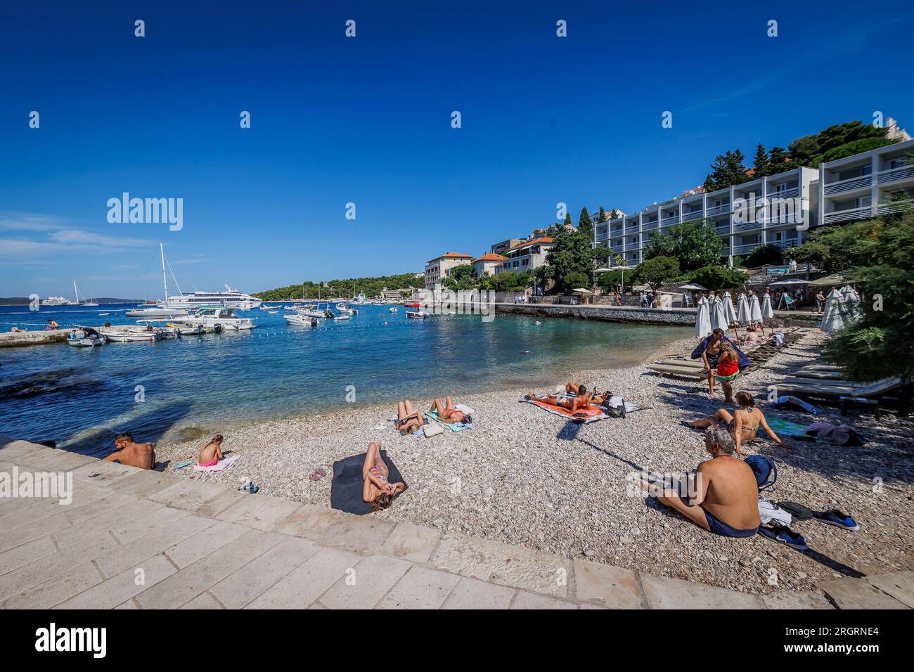 Split, Croatia. 11th Aug, 2023. Tourists sunbathes at the beach Lucica ...