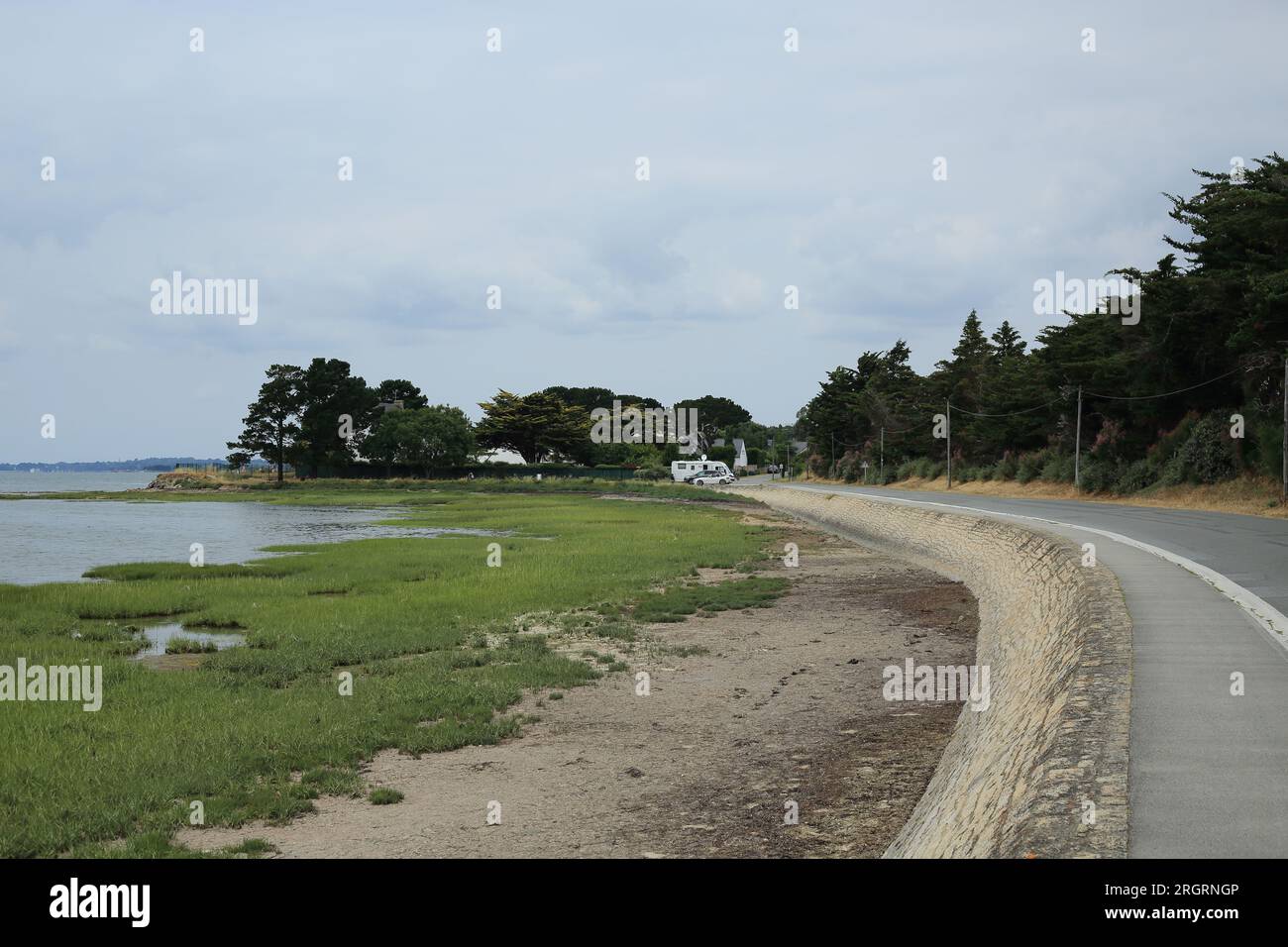Coastal road and bay at low tide with views across the Golfe du ...