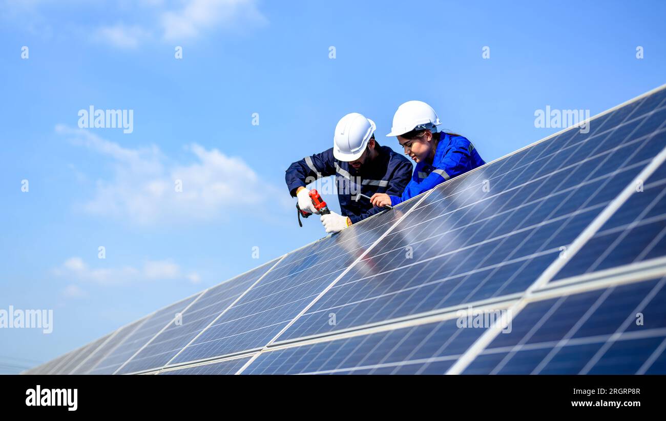 Technicians workers installing solar panels at solar cell farm Stock ...