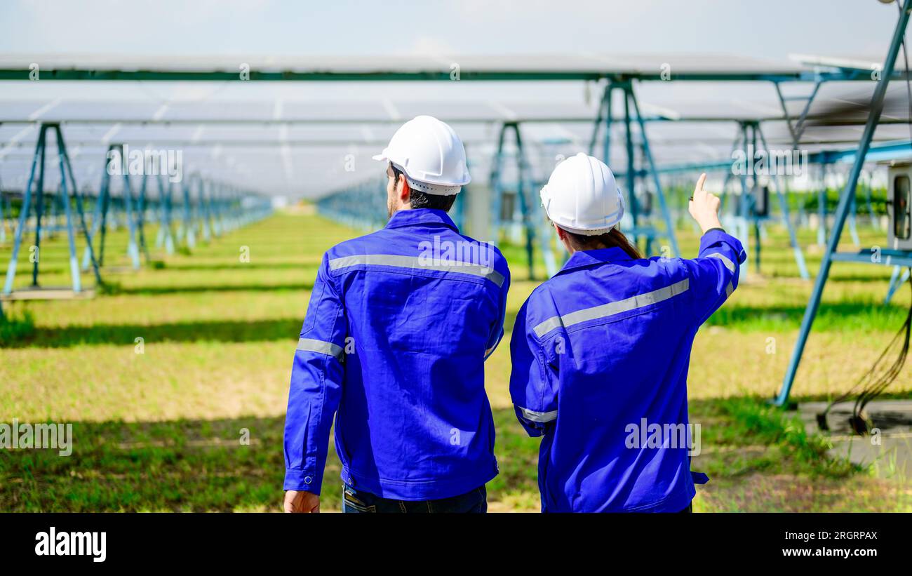 Technicians workers installing solar panels at solar cell farm Stock ...