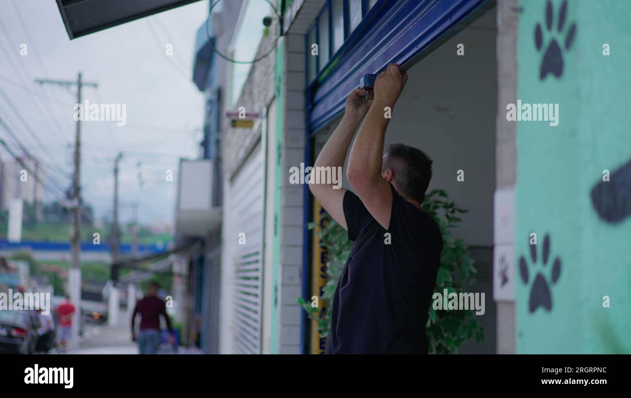 Man closing storefront garage in hi-res stock photography and images ...