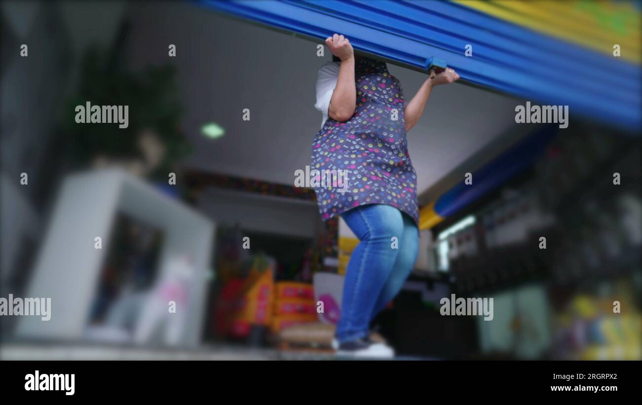 Woman opening Shop lifting garage. female local Business owner opens ...