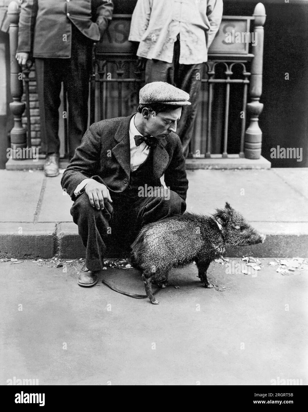Hollywood, California: c. 1928 Buster Keaton sitting on a curb with a ...
