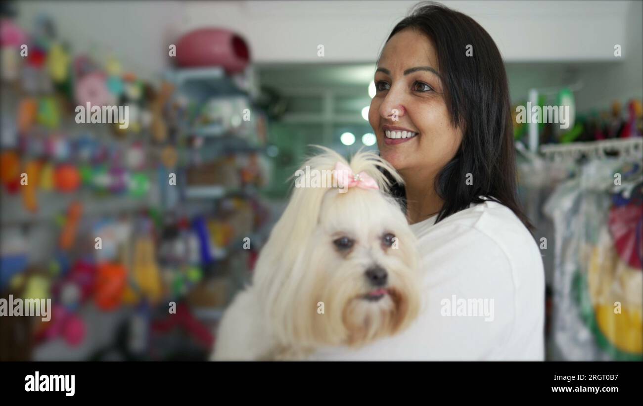 Pet Owner with Small Dog Exploring Product Aisle in Pet Store Stock ...