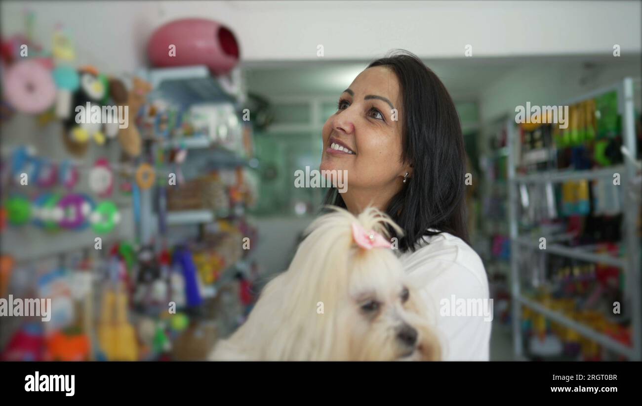 Pet Owner with Small Dog Exploring Product Aisle in Pet Store Stock ...