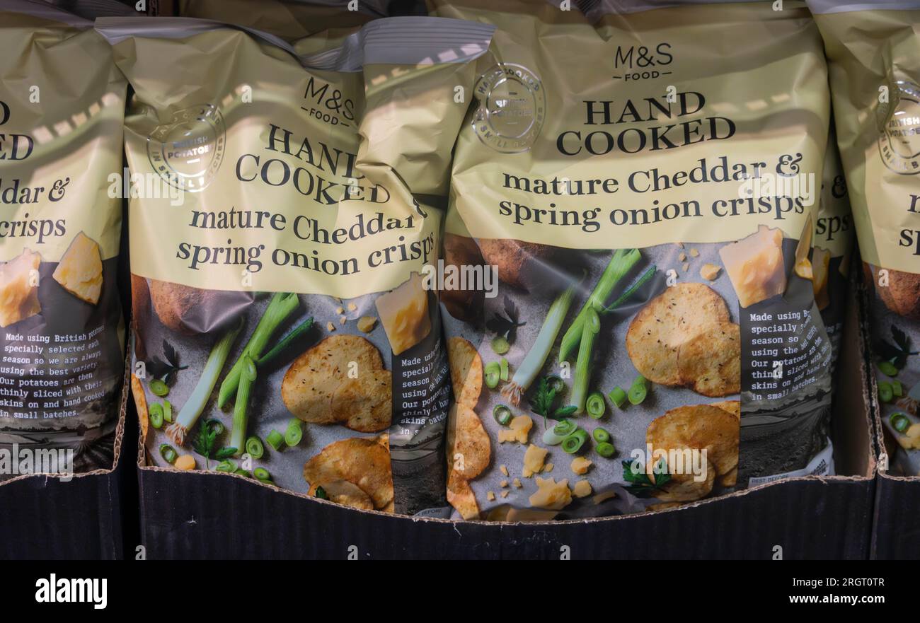 Hand Cooked mature cheddar & spring onion crisps Stock Photo - Alamy