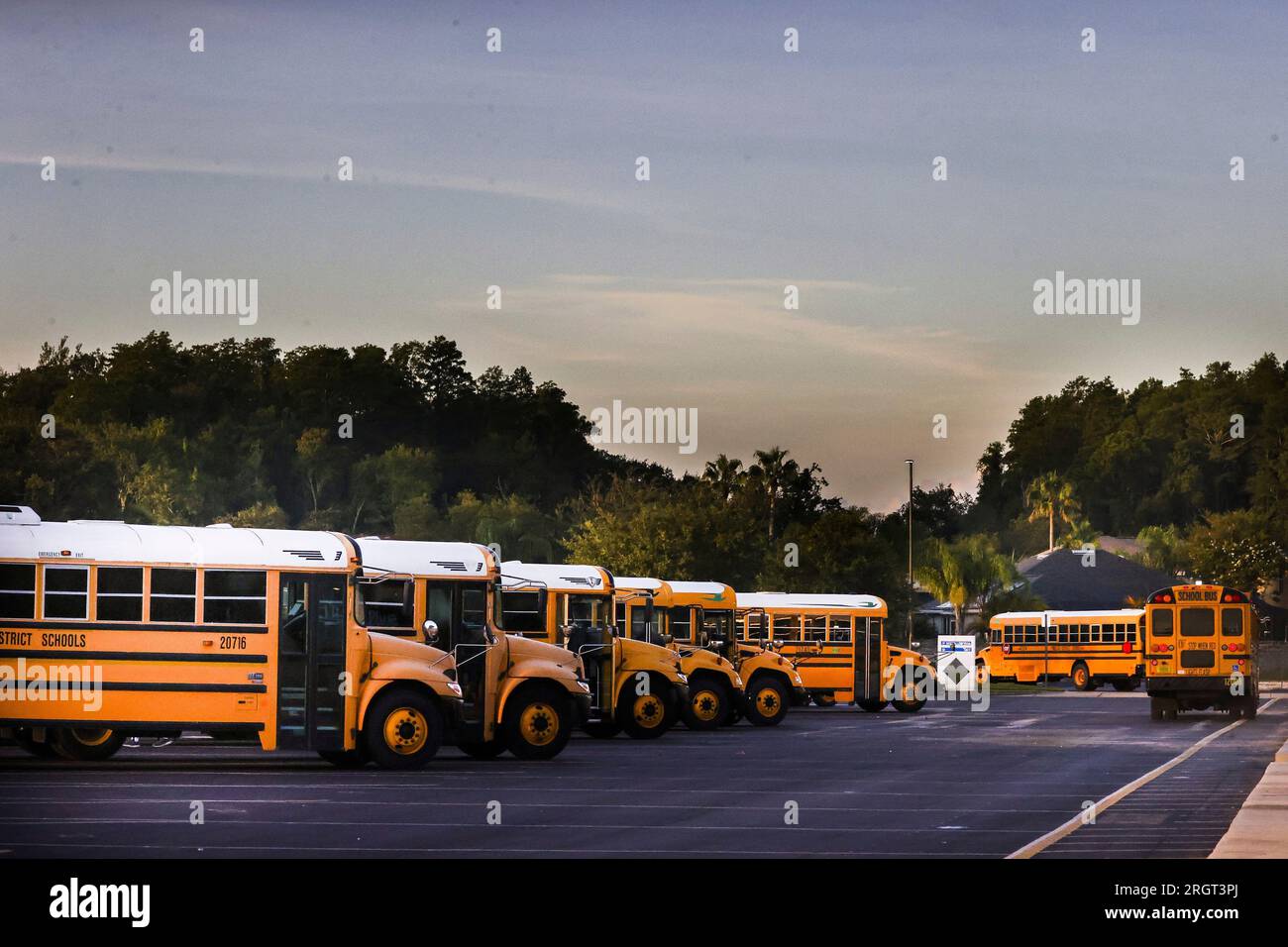 School buses line up in front of the school after dropping off students ...